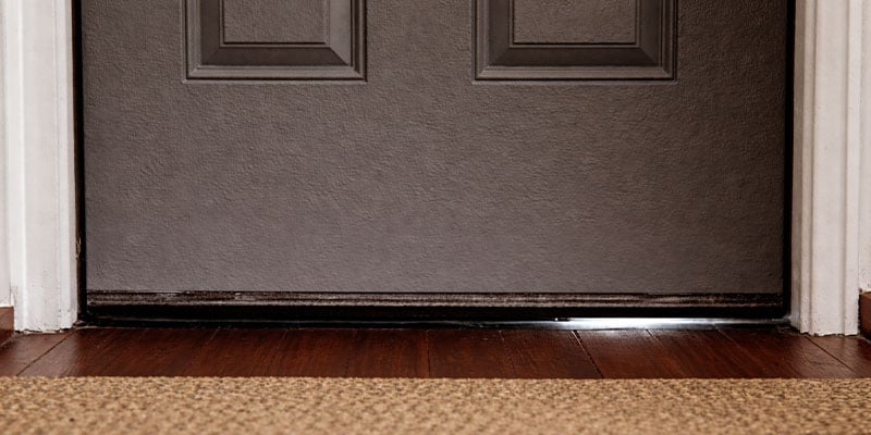 What Causes Entry Doors to Warp, Stick, or Crack? (And When It’s a Problem)